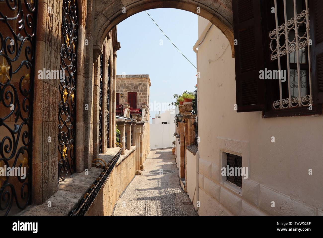 Narrow street in Lindos town on Rhodes island, Dodecanese, Greece ...