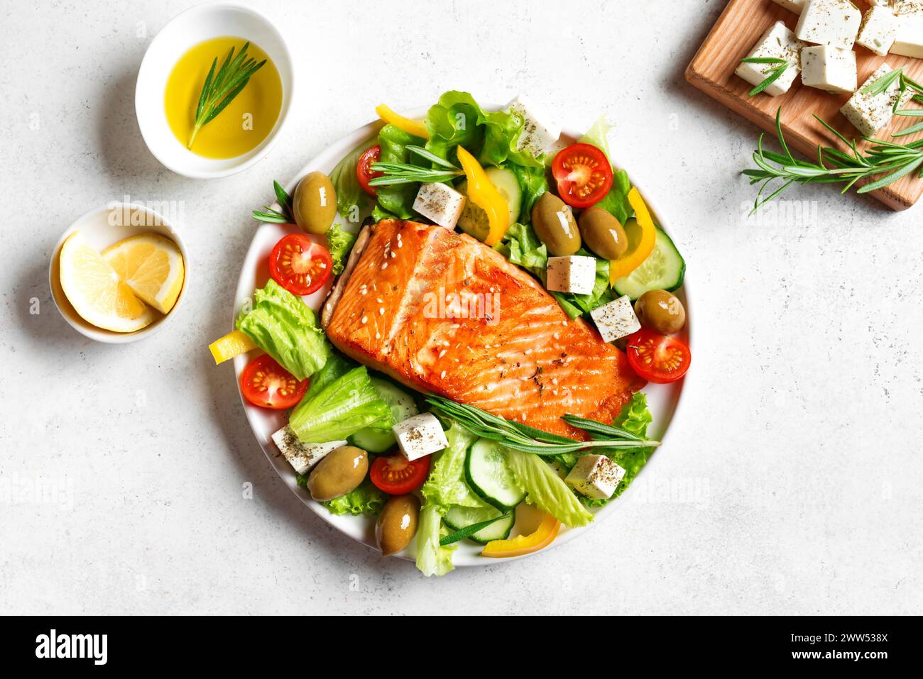 Grilled salmon fish fillet and fresh vegetable salad with tomato ...