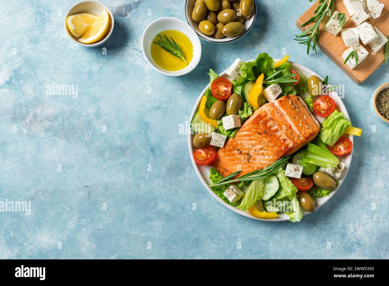 Grilled salmon fish fillet and fresh vegetable salad with feta cheese ...