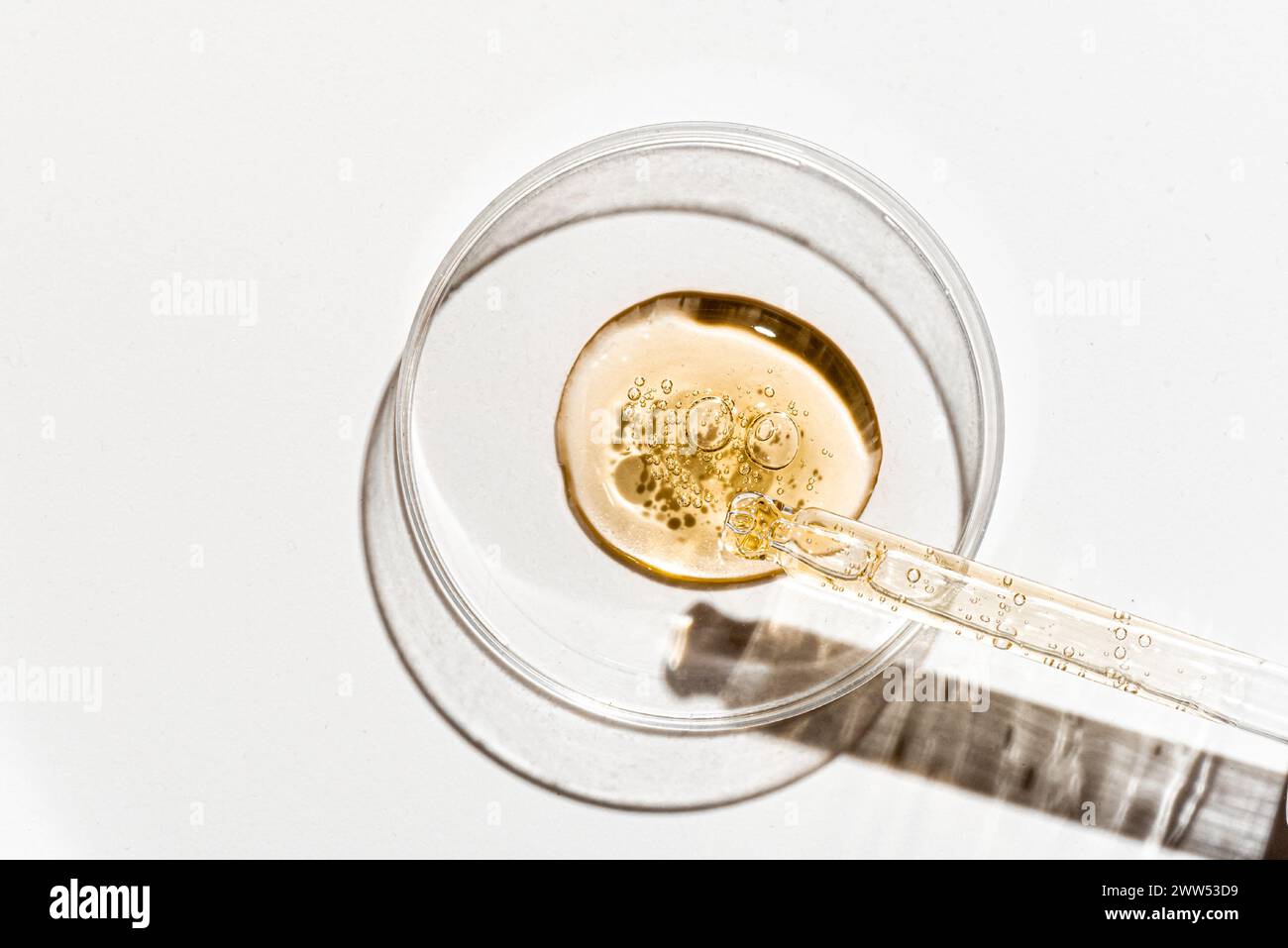 Retinol face serum sample in petri dish close up on white background ...