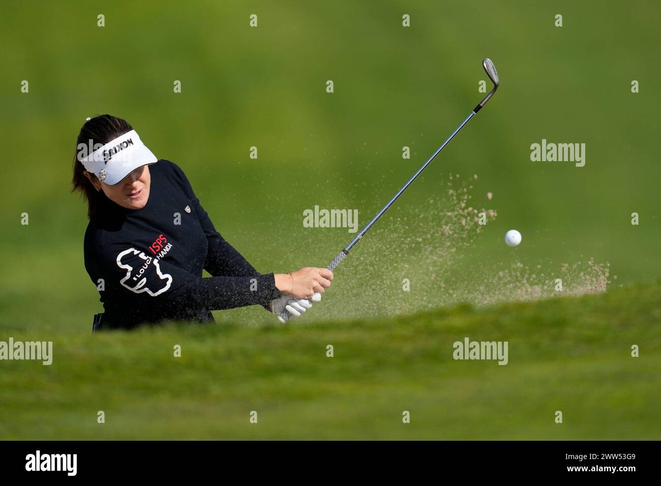 Hannah Green hits from the sand on to the 18th green during the first ...