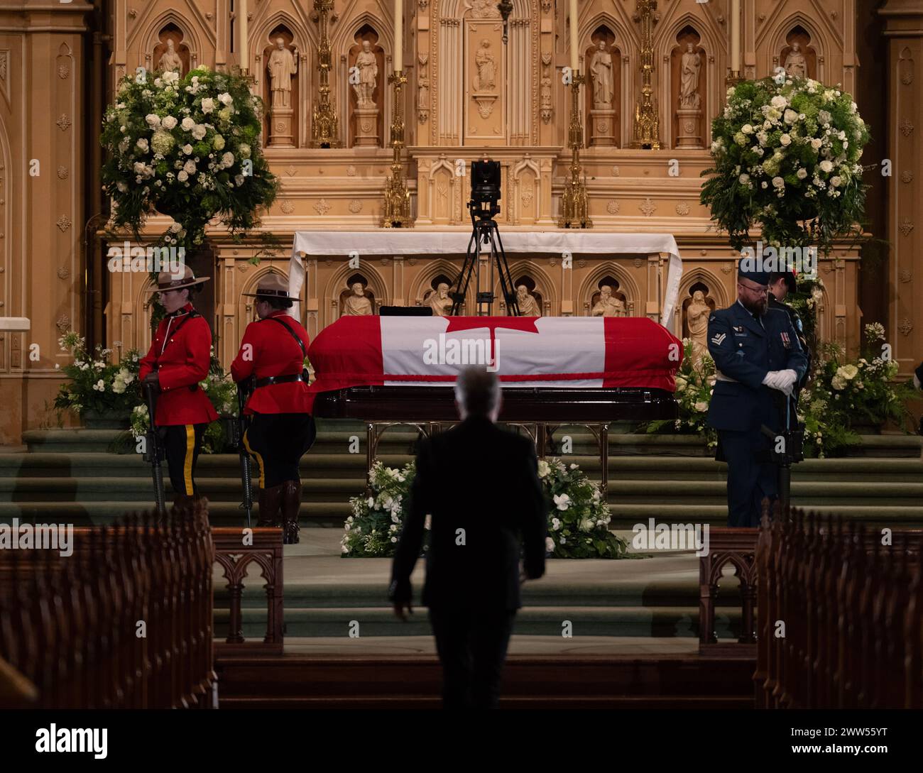 Montreal, Canada. 21st Mar, 2024. A person walks toward the casket of ...