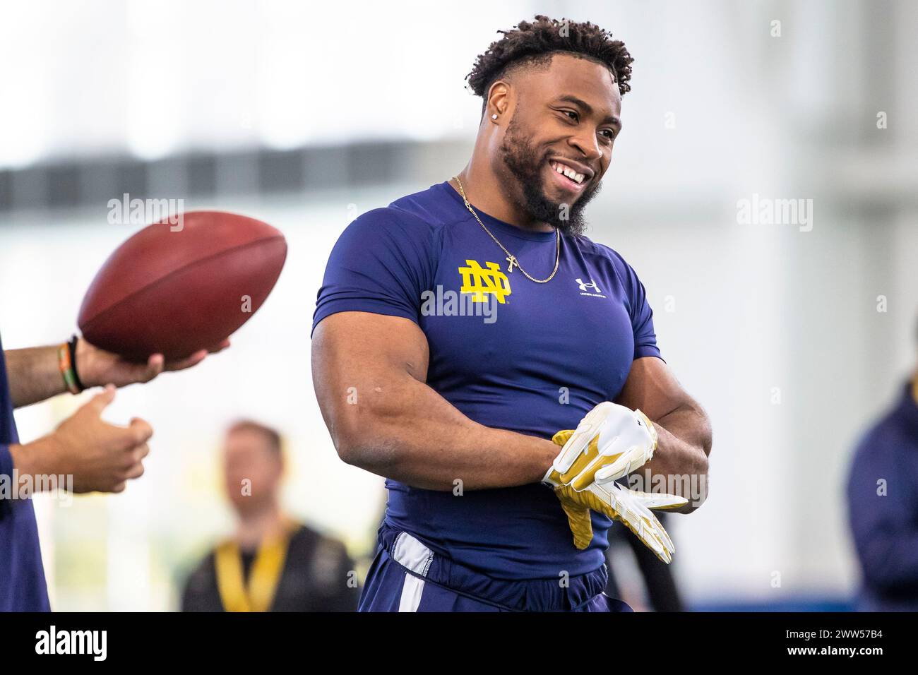 Notre Dame running back Audric Estime smiles as he adjusts his gloves ...
