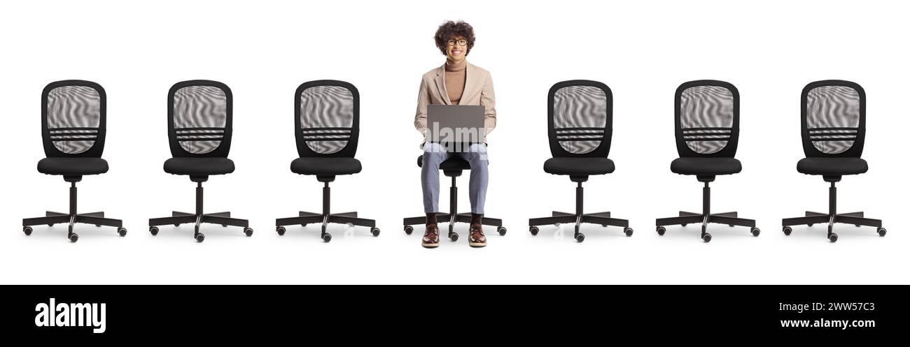 Empty Office Chairs And A Young Man Sitting And Using A Laptop Computer Isolated On White