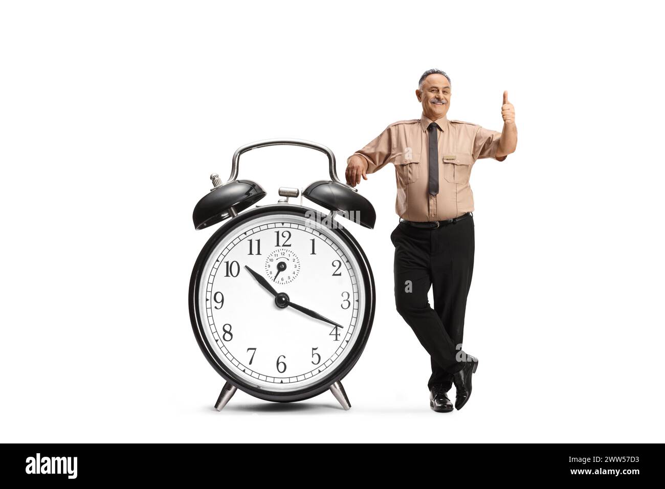 Security officer leaning on a big alarm clock and gesturing thumbs up ...