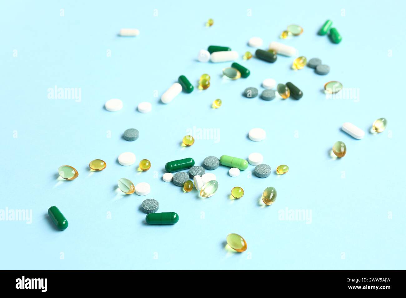 Fish oil capsules and different pills on blue background Stock Photo ...