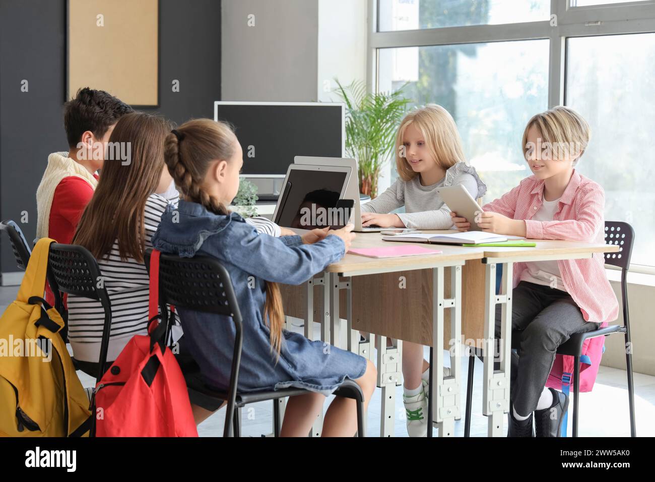 Little children studying with devices at school computer lab Stock ...