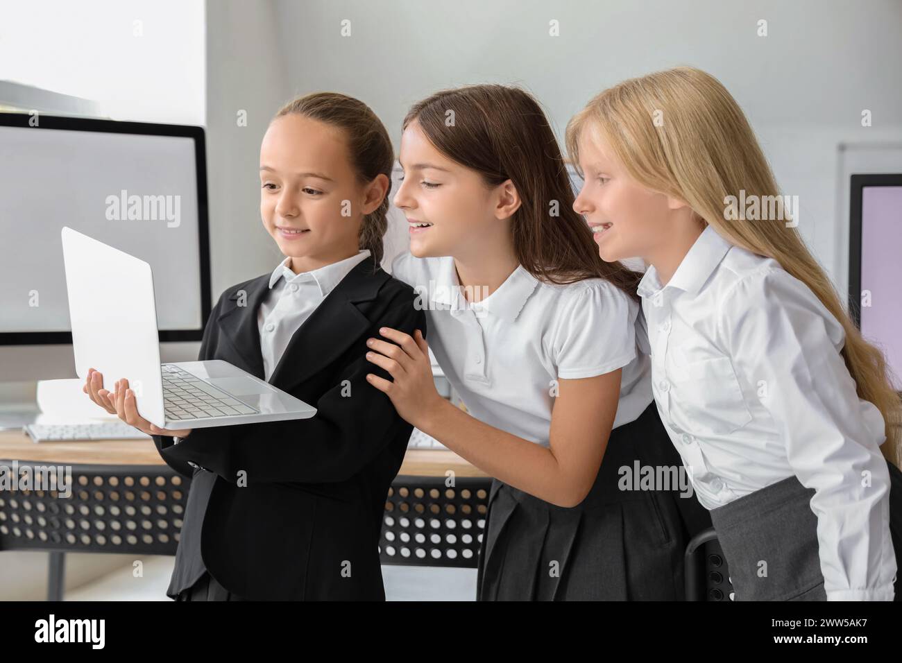 Little girls with laptop at school computer lab Stock Photo - Alamy