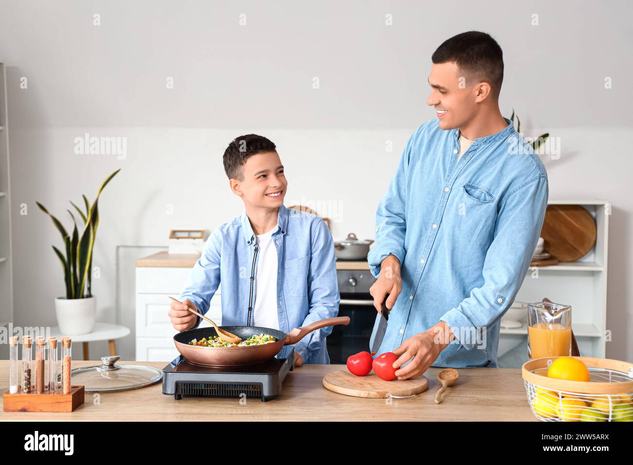 Little boy with his father cooking at home Stock Photo - Alamy