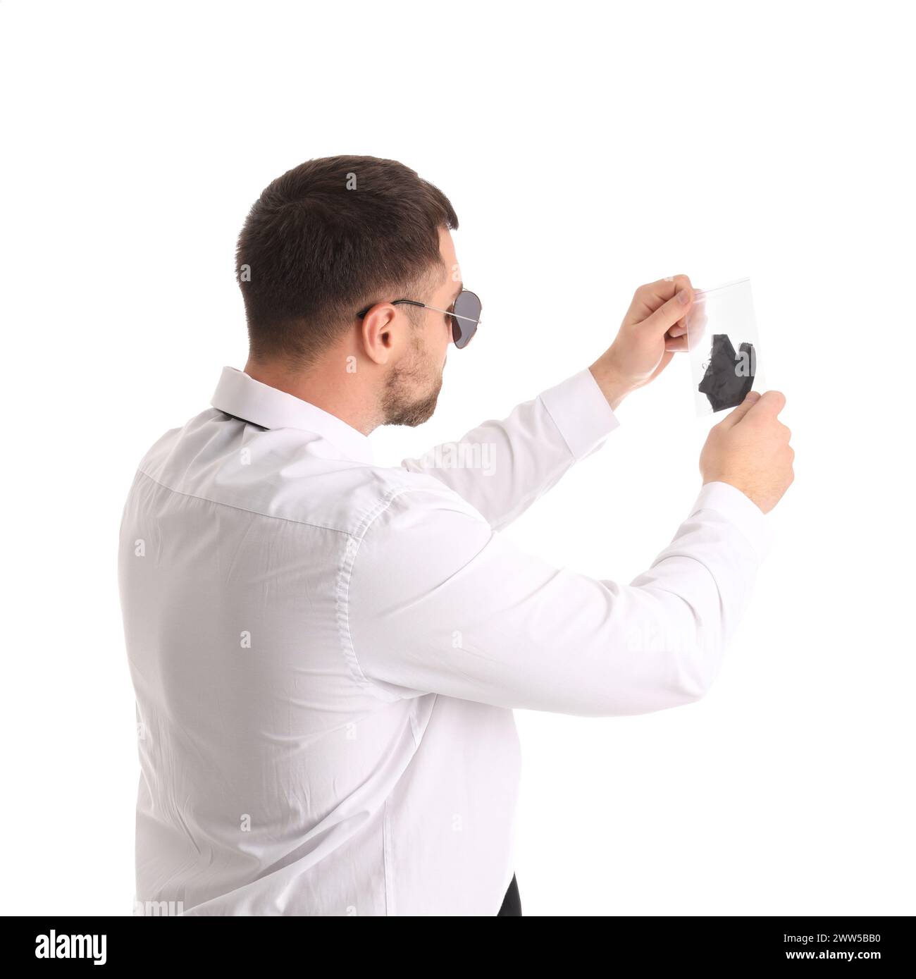 Male police officer with evidence on white background Stock Photo - Alamy
