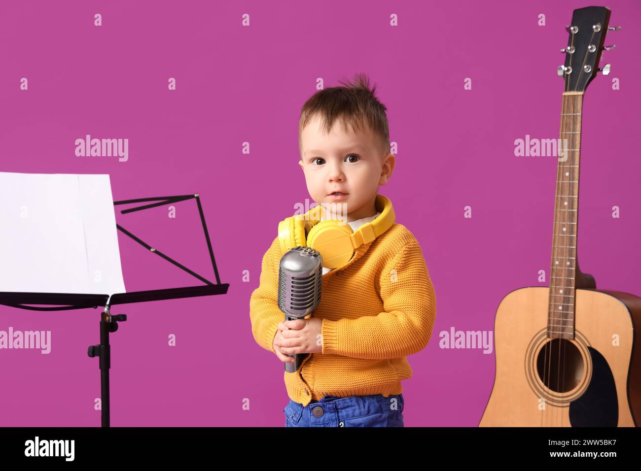 Cute little composer with microphone on pink background Stock Photo - Alamy