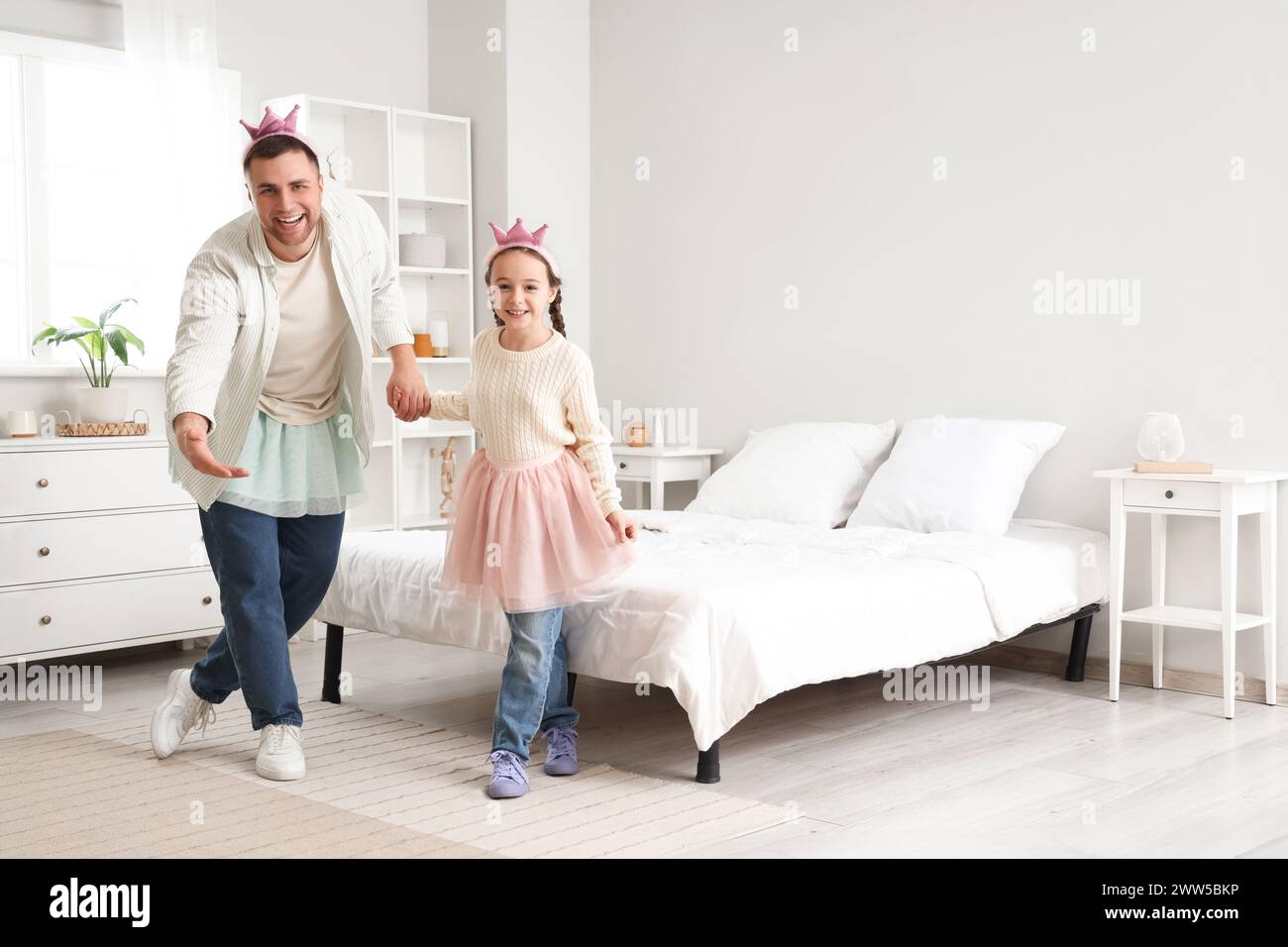 Father and his daughter in princess costumes playing in bedroom Stock ...