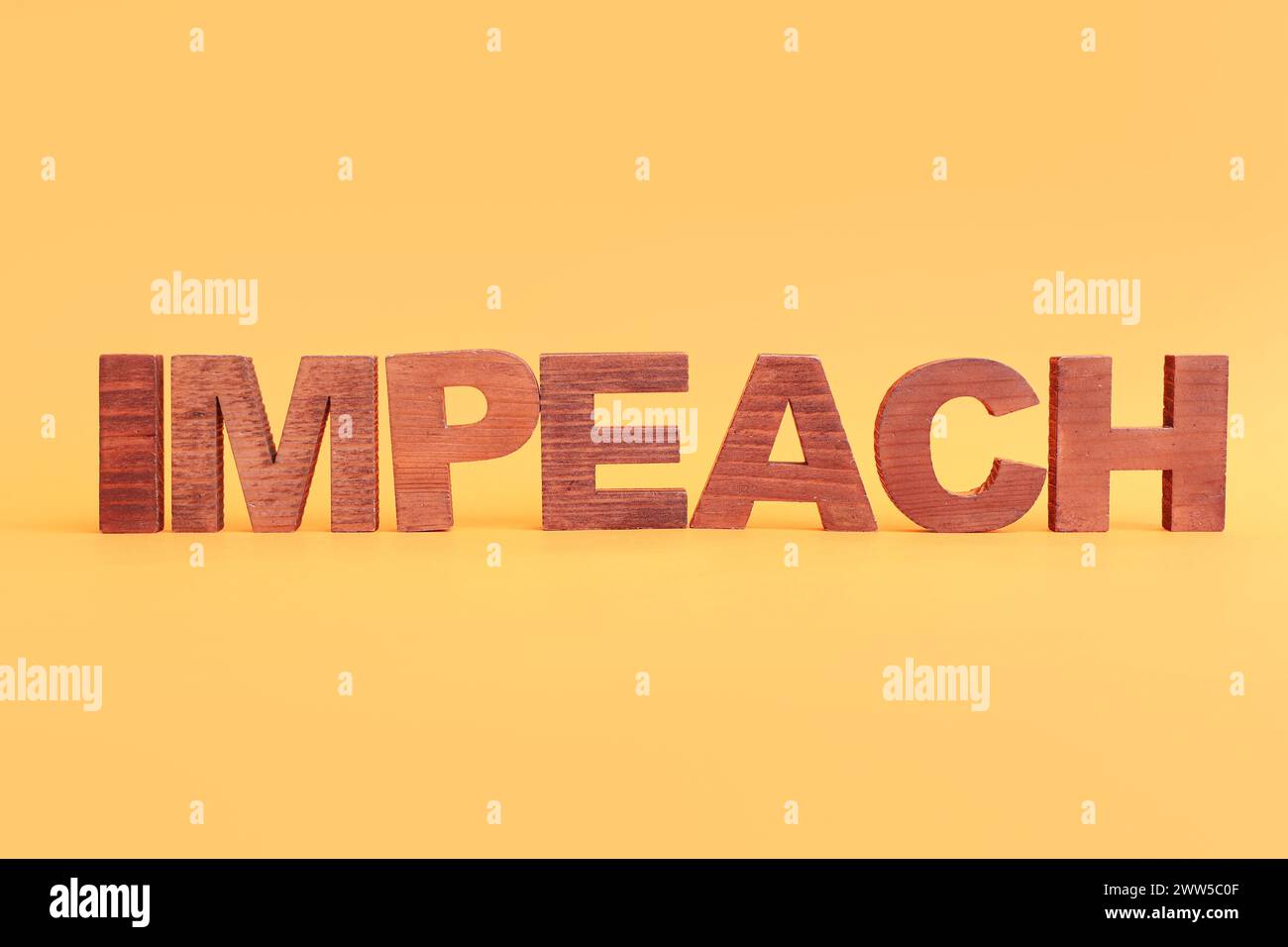 Wooden letters spelling word IMPEACHMENT on orange background Stock ...