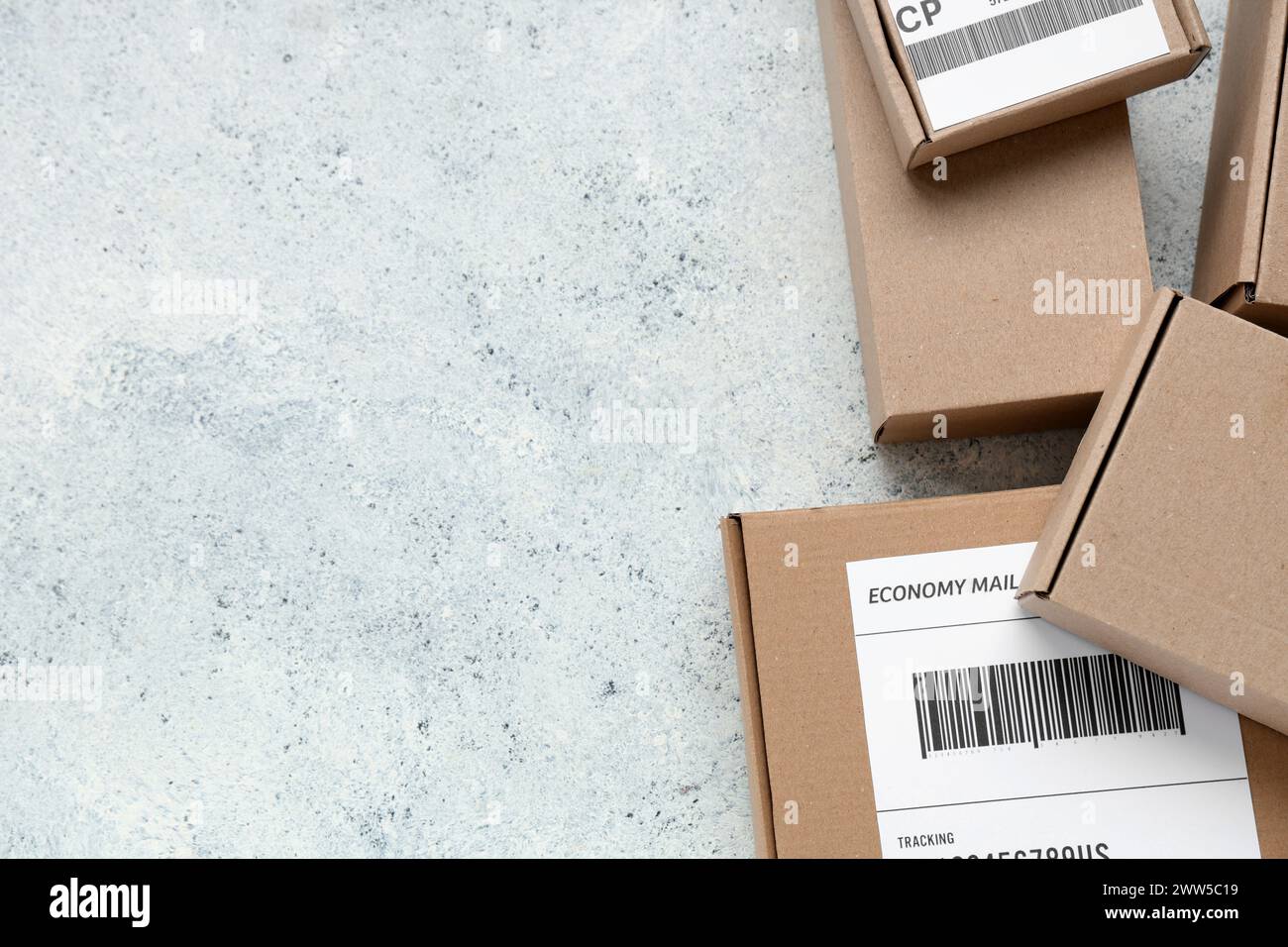 Cardboard packages with labels on white table Stock Photo - Alamy