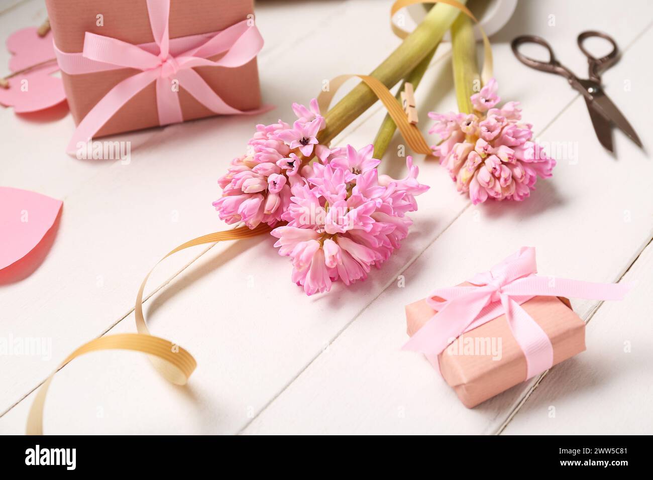 Beautiful hyacinths and small present on white wooden background Stock ...
