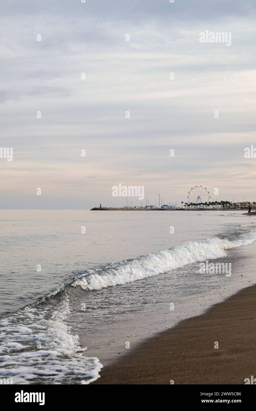 Sea scenery, waves breaking on the fork of a beach, in the background a ...