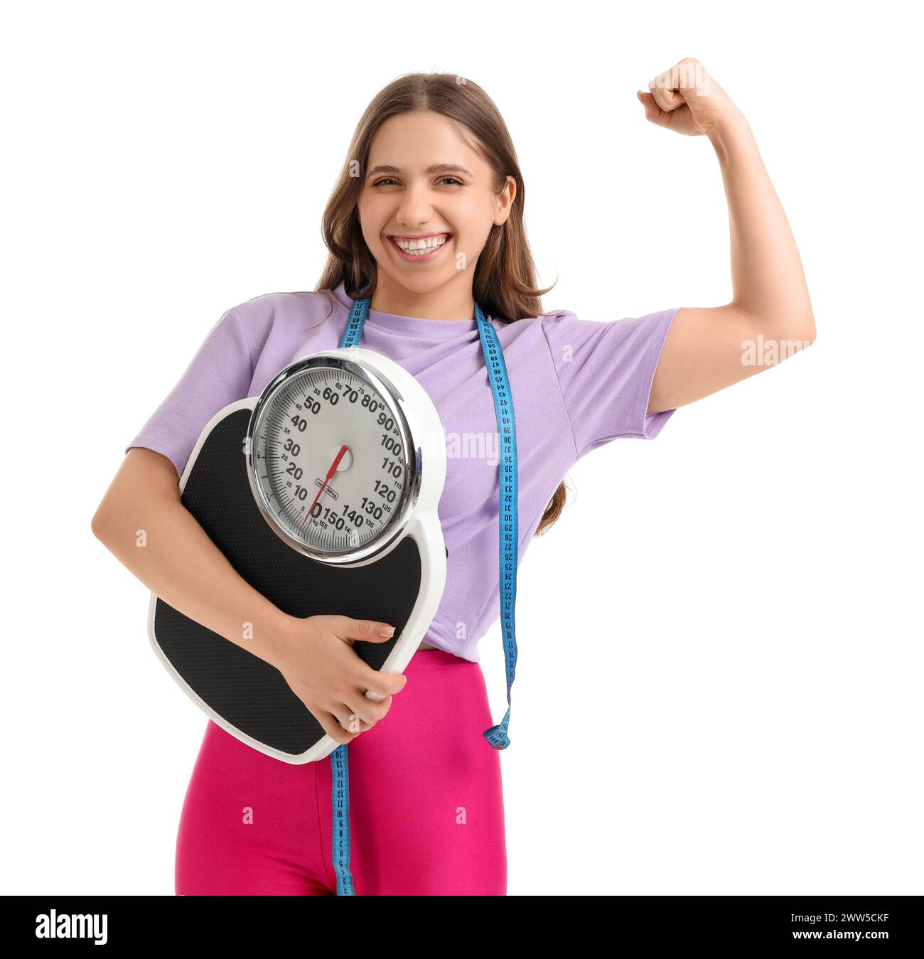 Pretty young woman in sportswear with scales and measuring tape showing ...