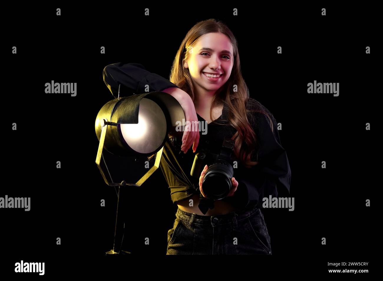Female photographer with modern camera and spotlight lamp on black ...