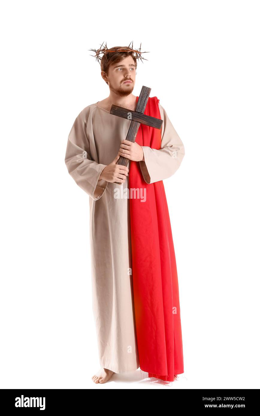 Man in Jesus robe and crown of thorns holding wooden cross on white ...