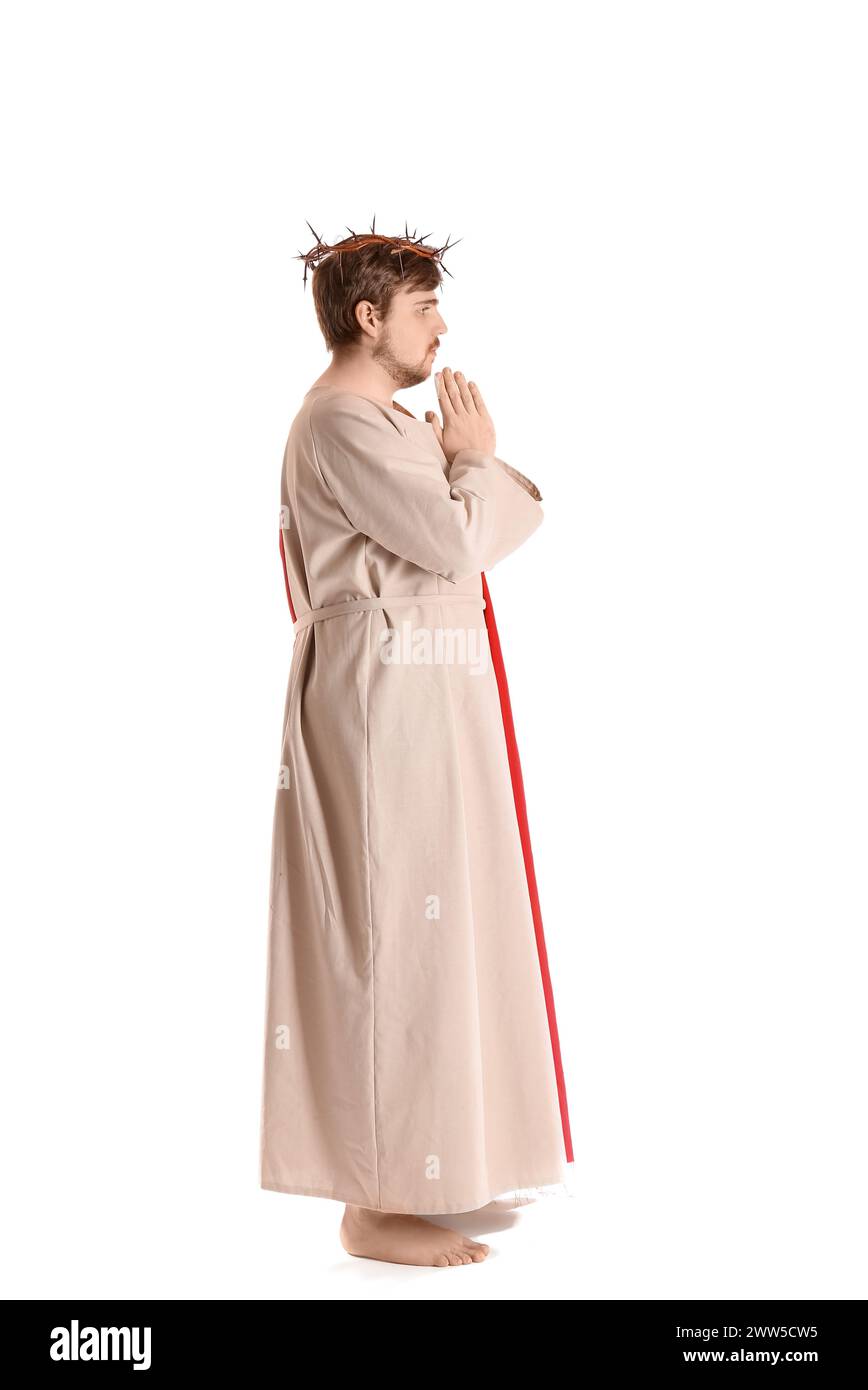 Man in Jesus robe and crown of thorns praying on white background Stock ...