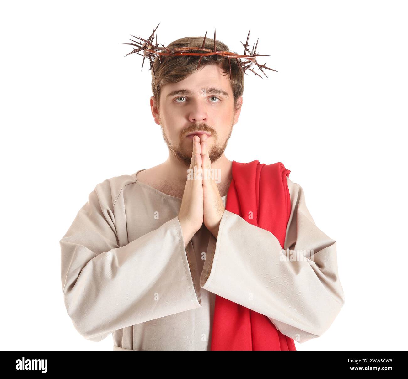 Man in Jesus robe and crown of thorns praying on white background Stock ...