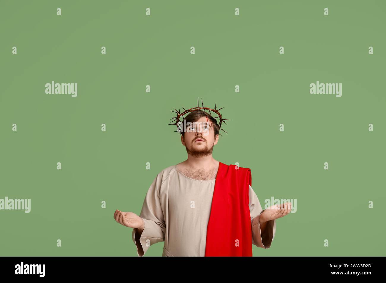 Man in Jesus robe and crown of thorns with blood, outstretching hands ...