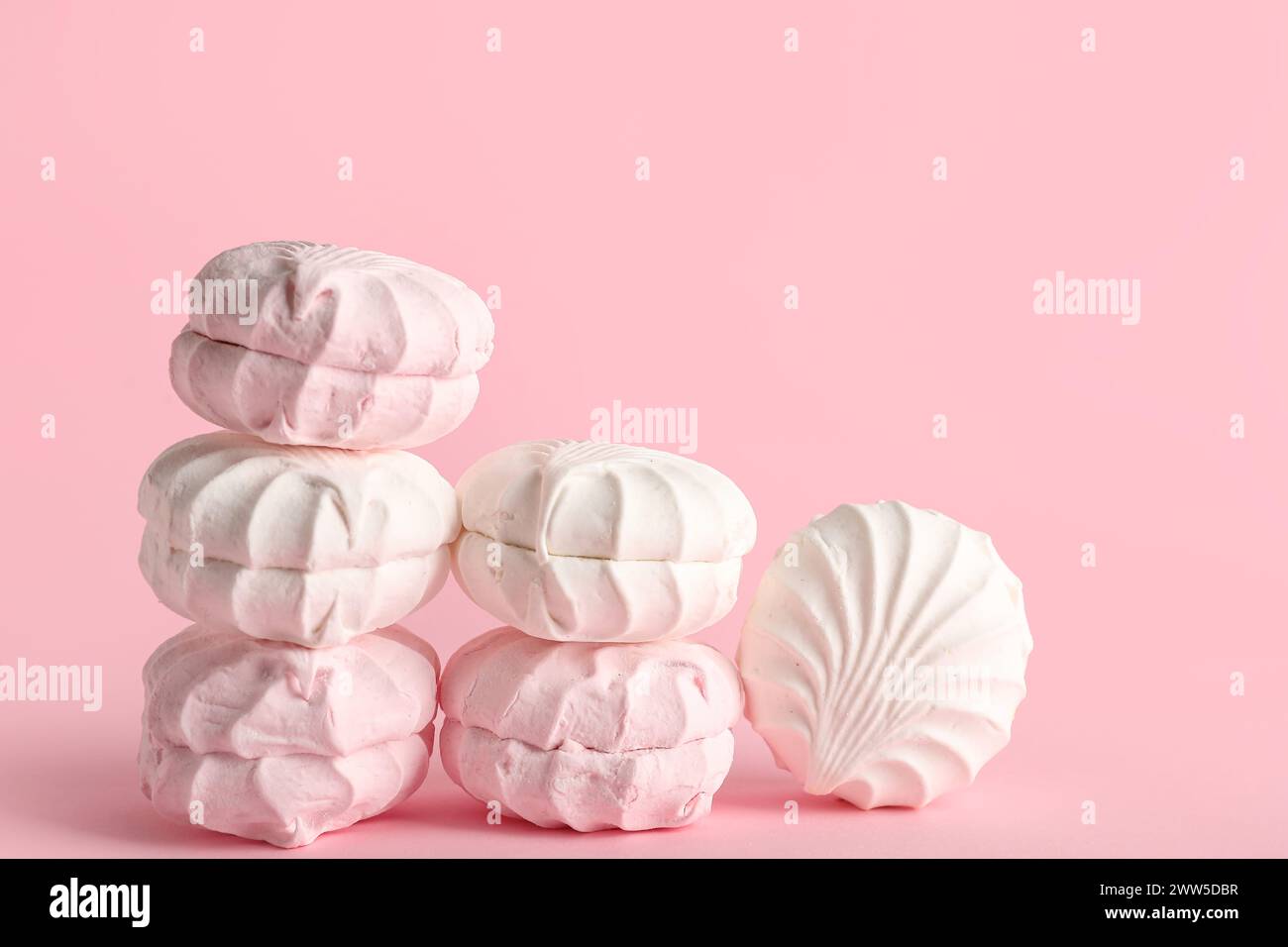 Many sweet zephyr on pink background Stock Photo - Alamy