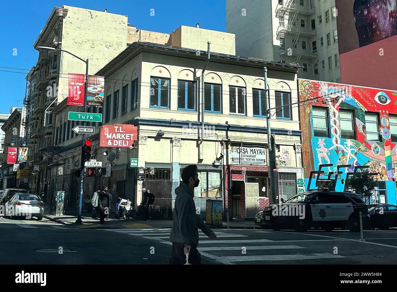 A pedestrian walks along Turk Street in the Tenderloin neighborhood in ...