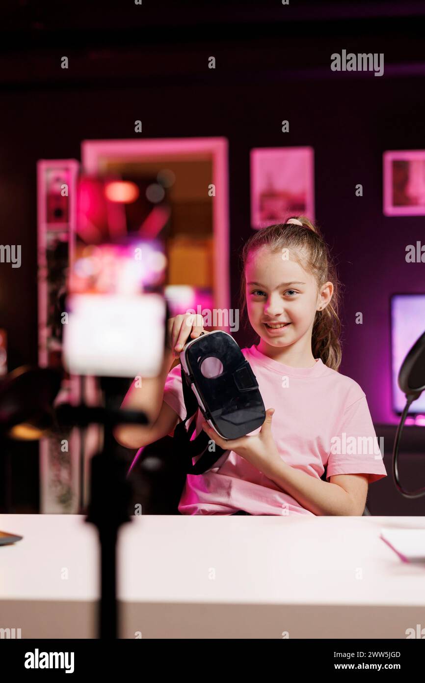 Kid filming sponsored content, unboxing newly released VR glasses ...