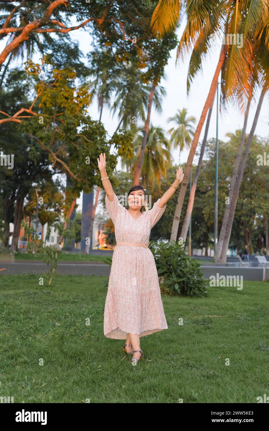 Woman with positive attitude raising her arms and shouting for joy in a ...