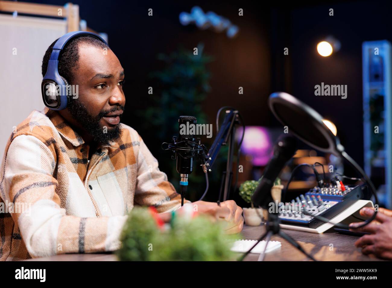 Man talk show host using audio equipment and having a friendly ...