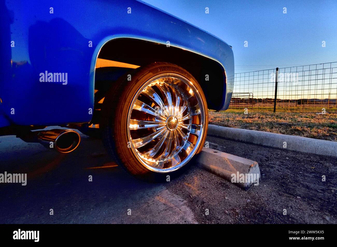 Classic blue Chevy Pickup with chrome mag wheels and reflected sunshine ...