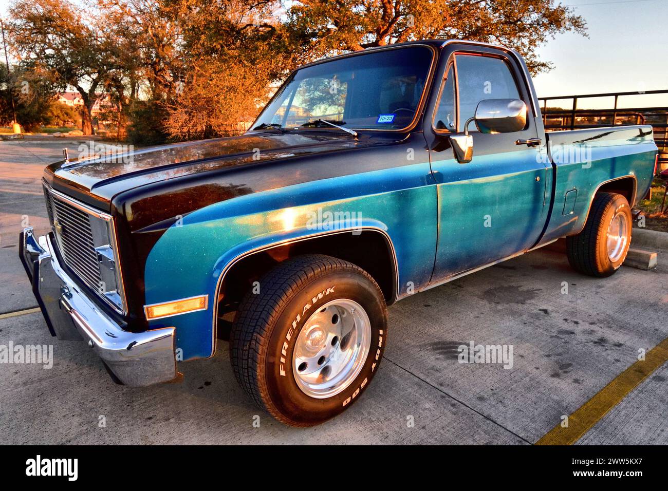 Classic blue and black Chevy Pickup with mag wheels and reflected ...