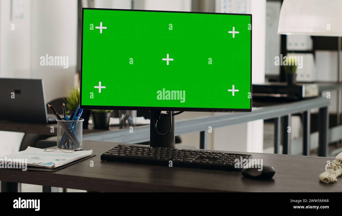Workstation desk with greenscreen monitor in business agency office ...