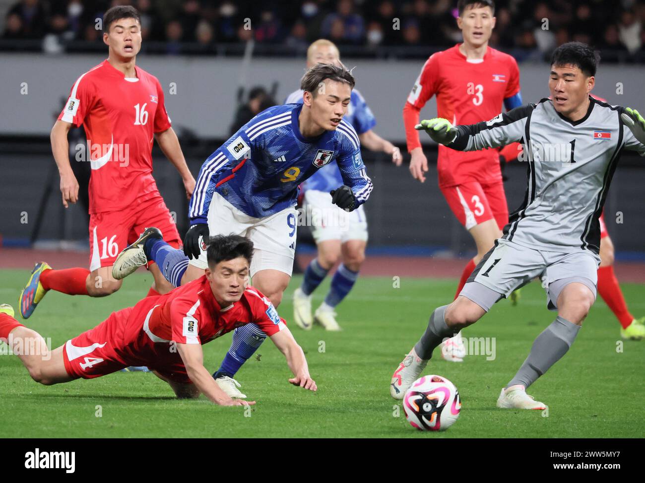 Tokyo, Japan. 21st Mar, 2024. Japan's Ayase Ueda (C) fights the ball ...