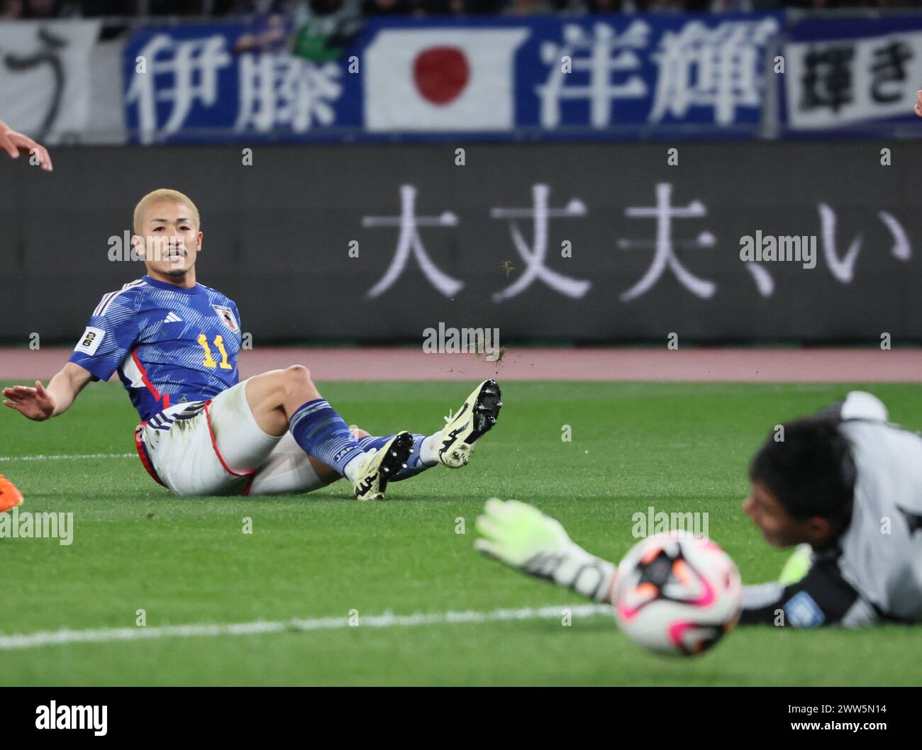Tokyo, Japan. 21st Mar, 2024. Japan's Daizen Maeda (L) shoots the ball ...
