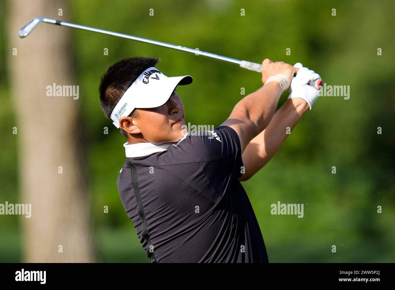 Carl Yuan, of China hits his tee shot on the eighth hole during the ...