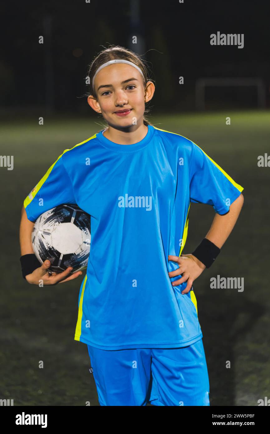 football and athlete kids concept, young and cute football player girl ...