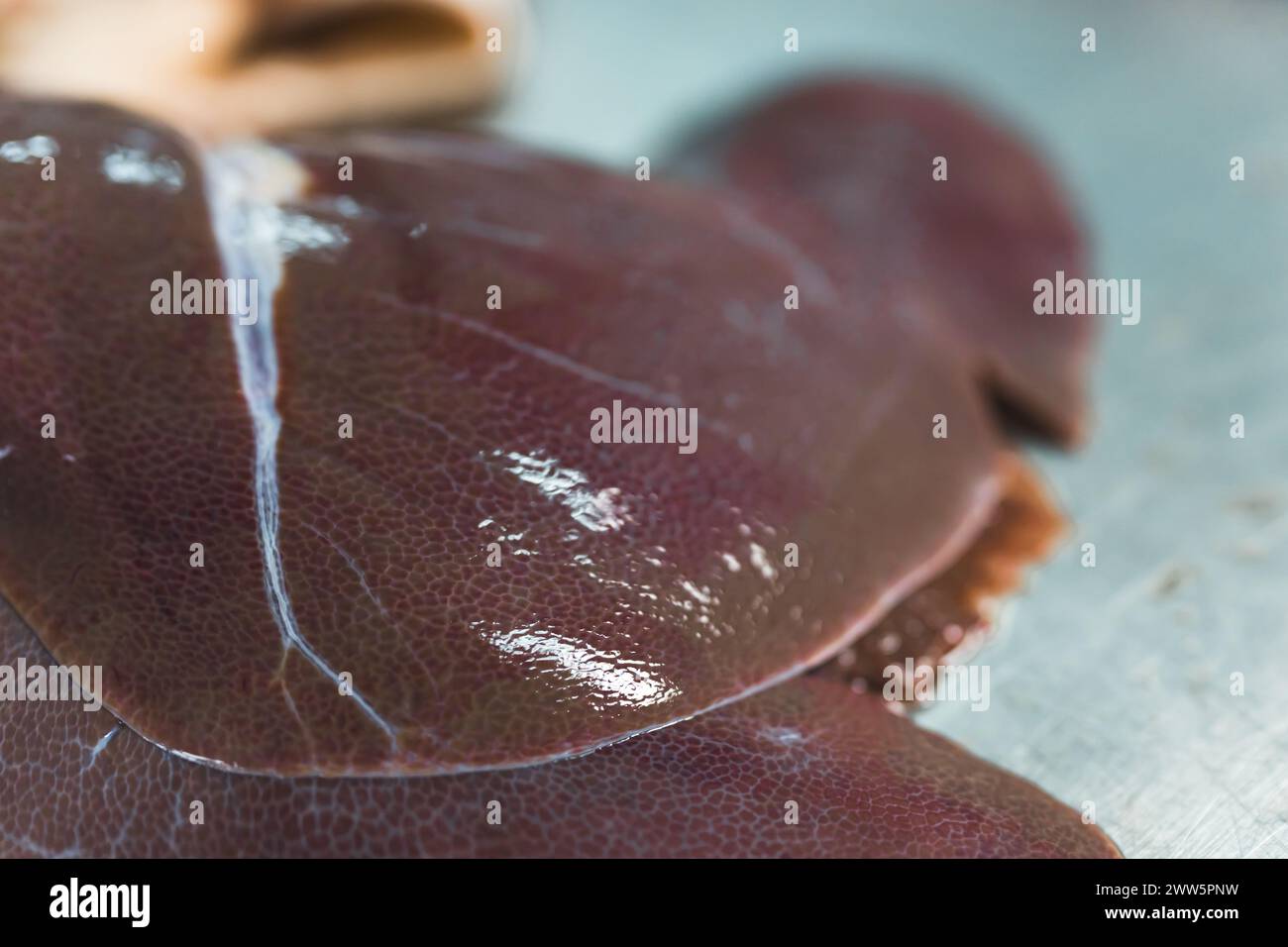 closeup shot of pig liver, cutting pig meat at the butchers shop, food ...