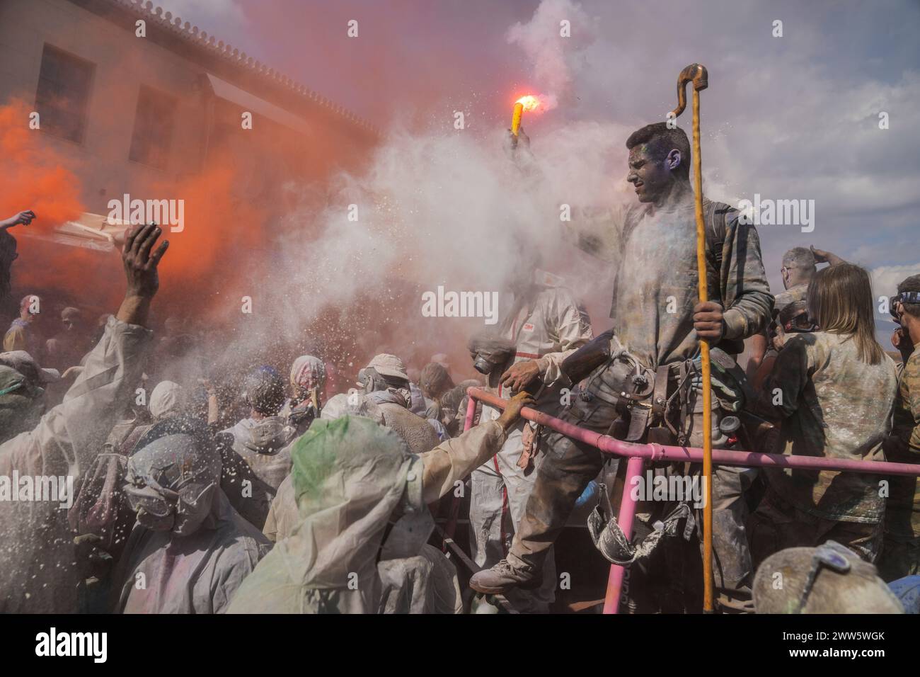 Revelers throw flour as they participate in the flour war, a unique ...