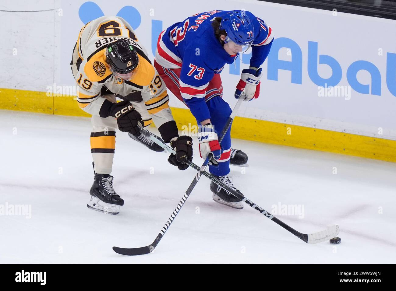Boston Bruins center Johnny Beecher (19) and New York Rangers center ...