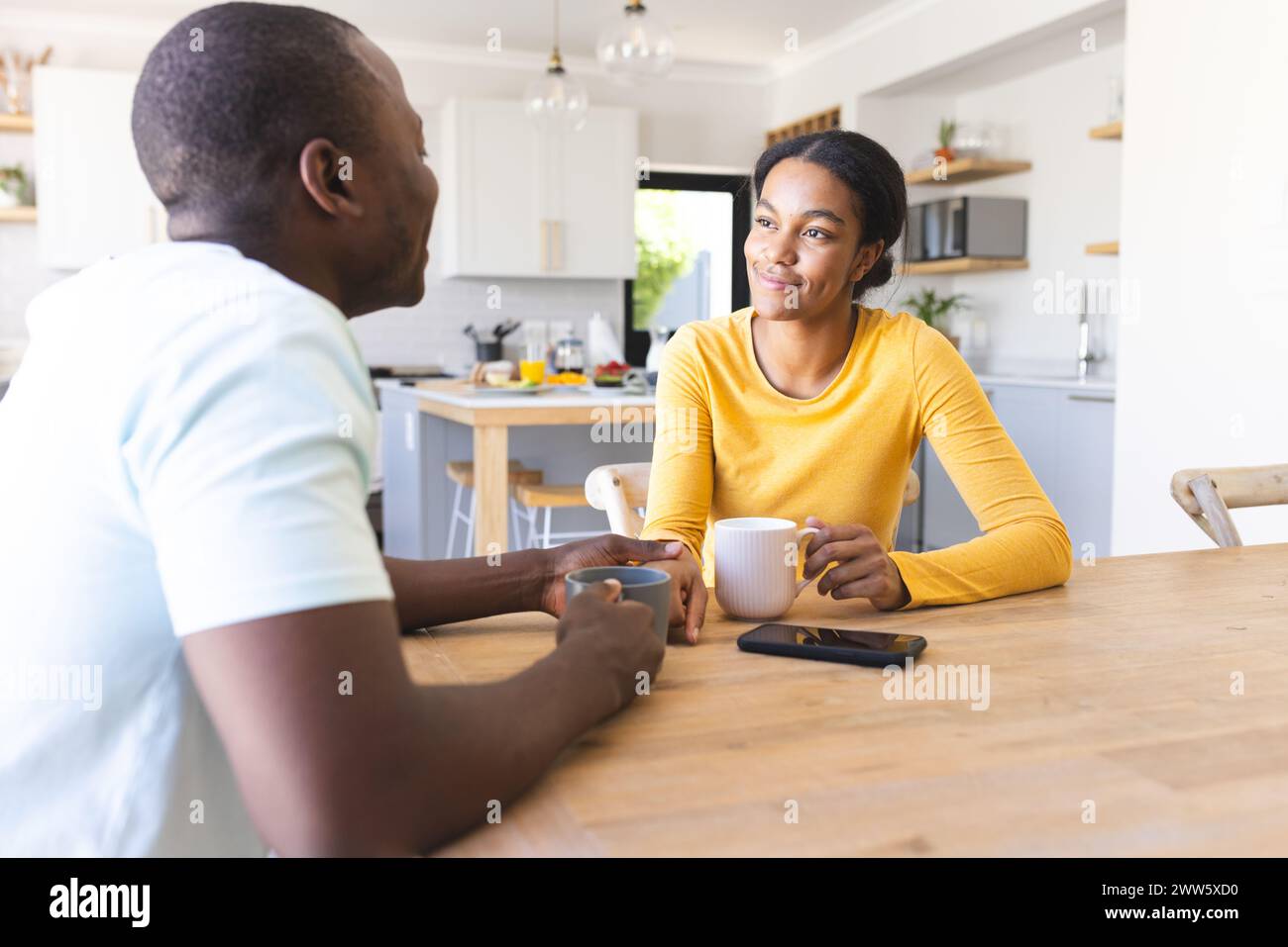 African American couple enjoys a conversation over coffee at home in ...