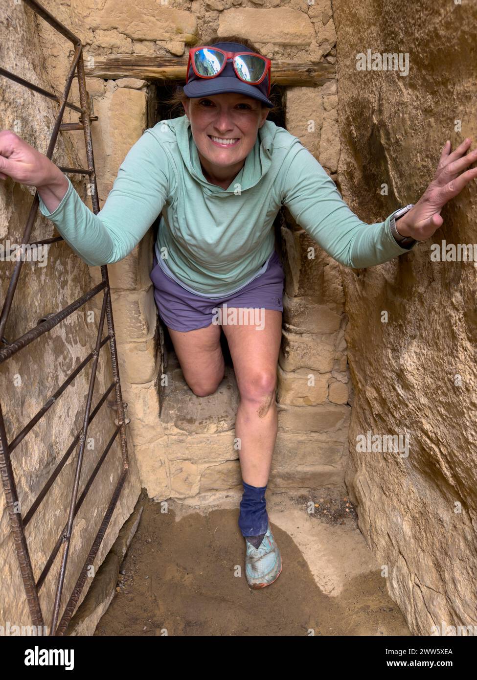 Woman Pops Out of Narrow Walkway through Cliff Dwelling in Mesa Verde ...
