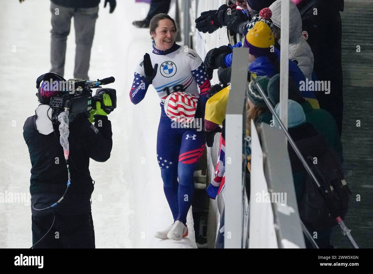 Katie Uhlaender, of the United States, center, greets fans after ...