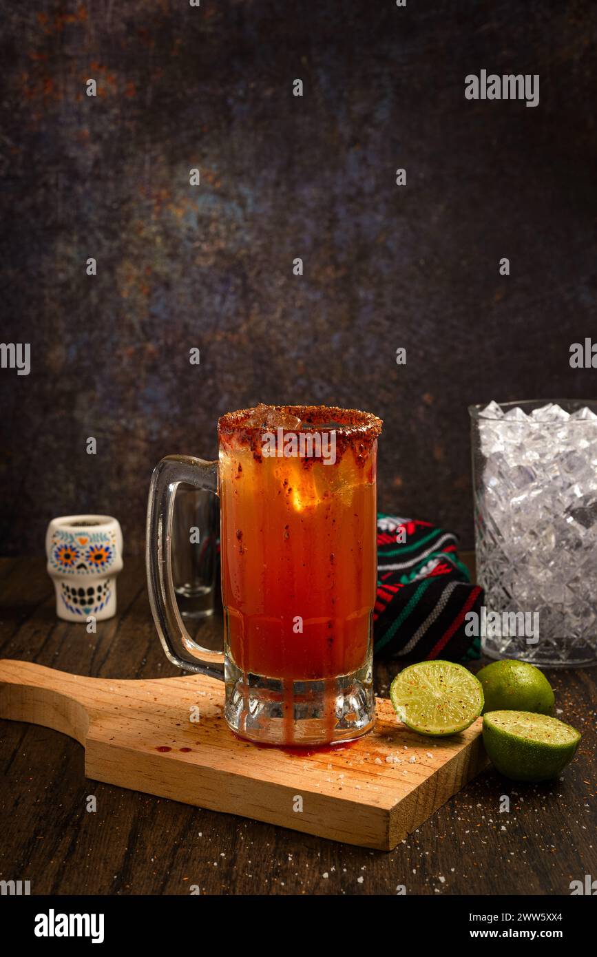 Michelada, typical mexican cocktail on a wooden table. Beer cocktail ...