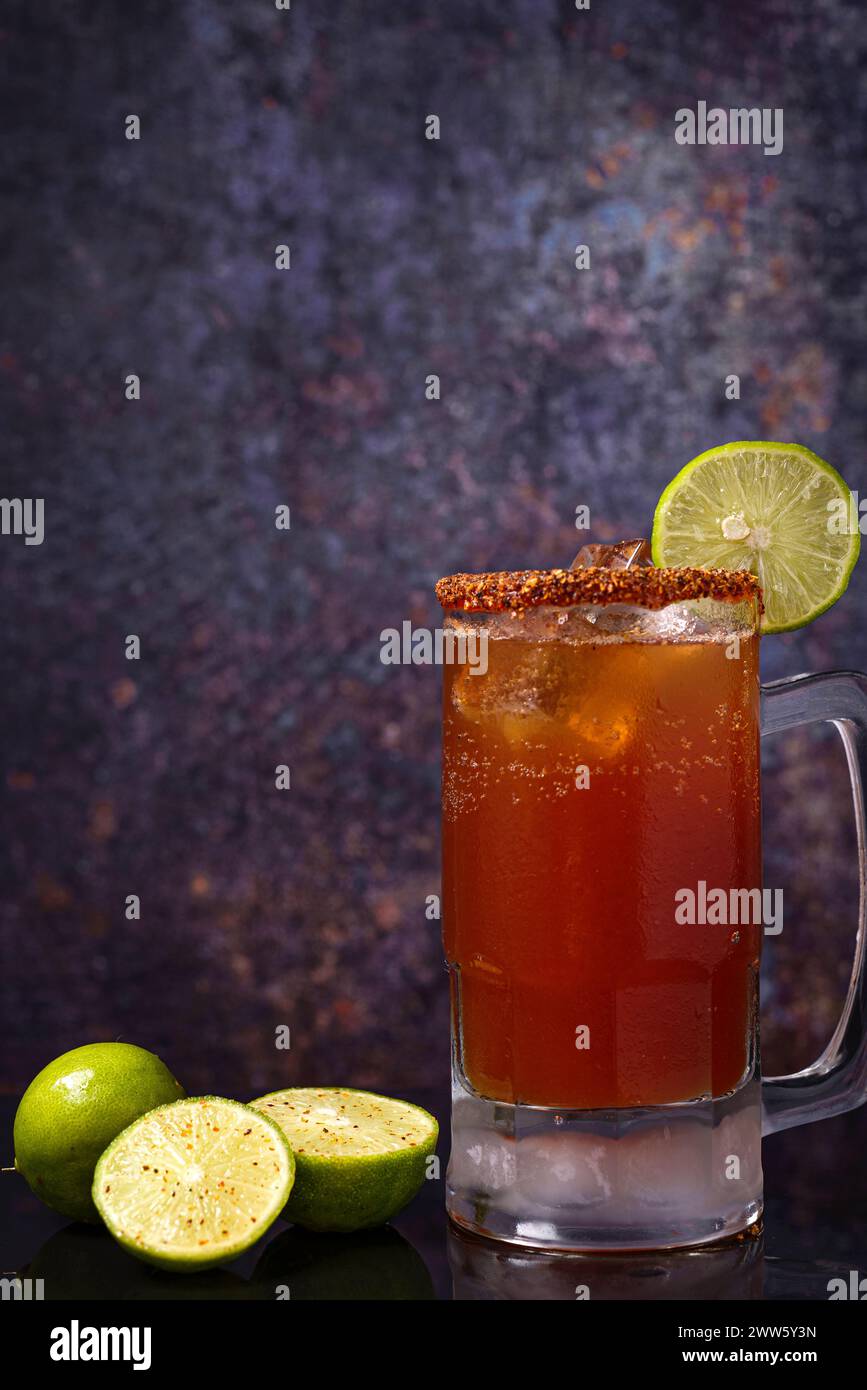 Michelada, typical mexican cocktail on a wooden table. Beer cocktail ...