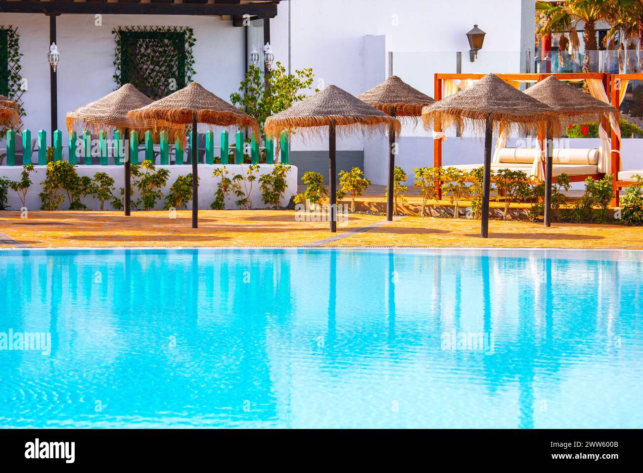 Swimming pool with sun loungers and umbrellas at luxury hotel resort ...