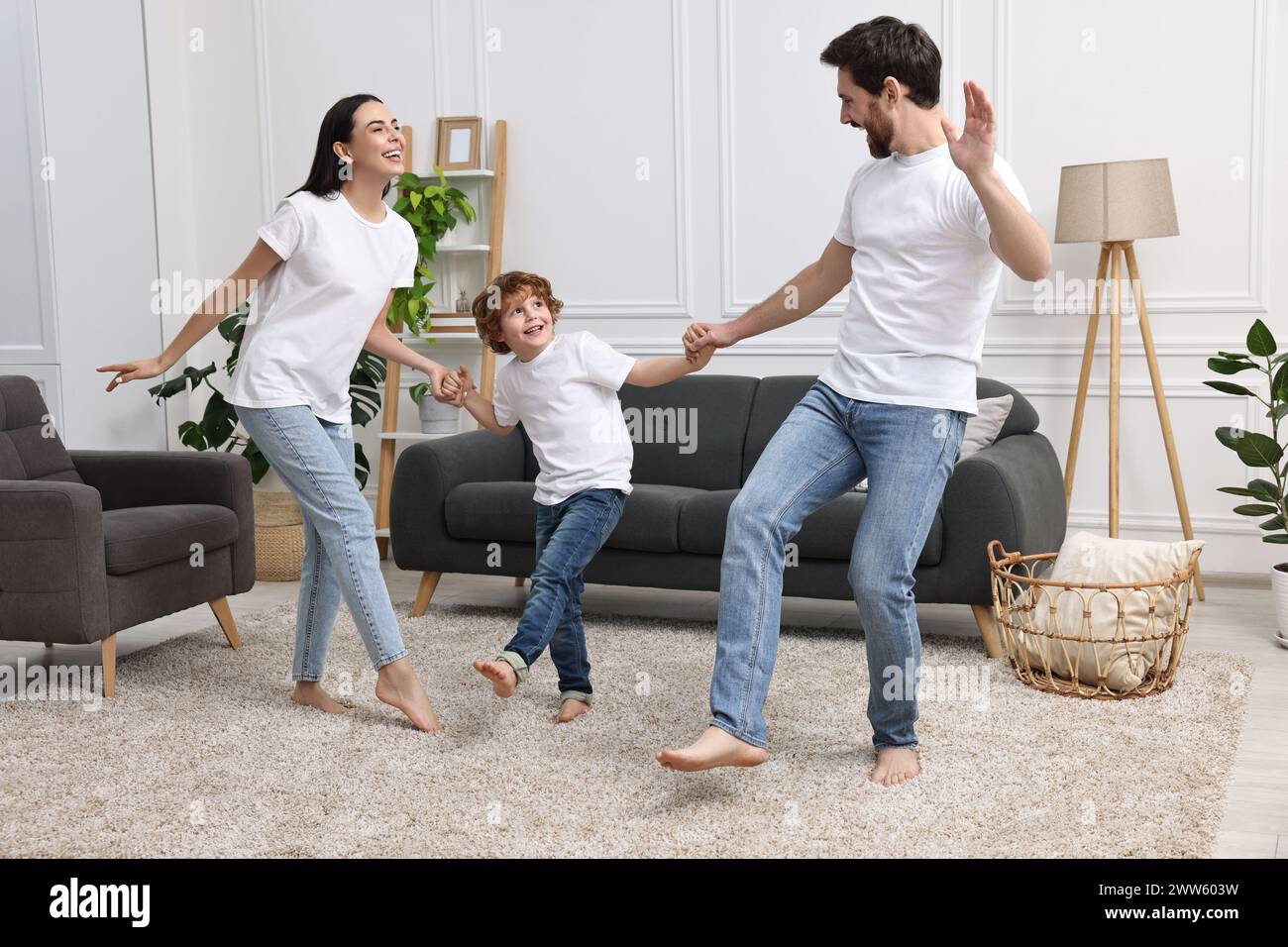 Happy family dancing and having fun in living room Stock Photo - Alamy