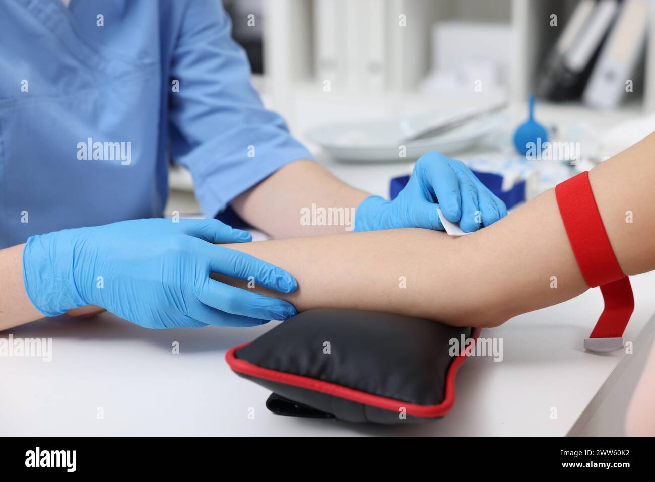 Laboratory testing. Doctor taking blood sample from patient at white ...