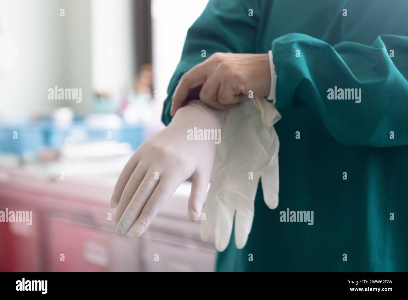 Doctor putting on surgical gloves , professional medical safety and ...